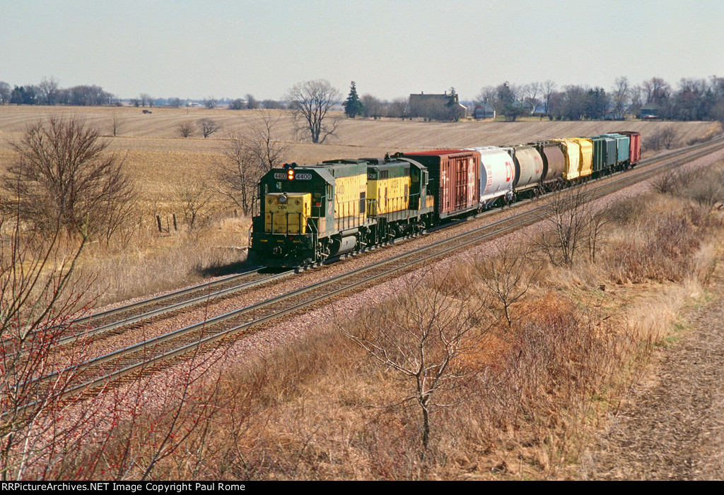 C&NW 4400, EMD GP15-1, and CNW 4328 make up the West Chicago Yard local working westbound with ...
